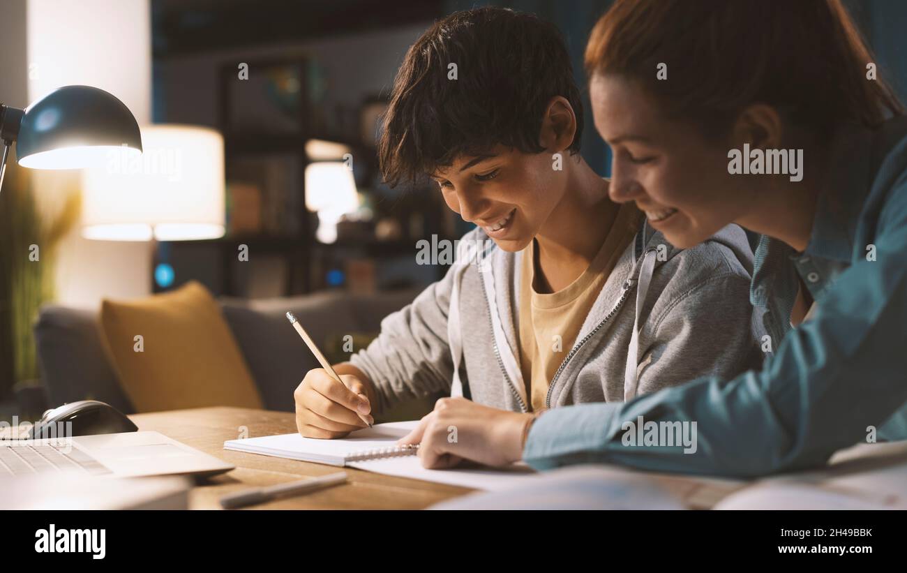 Two students help children hi-res stock photography and images - Alamy