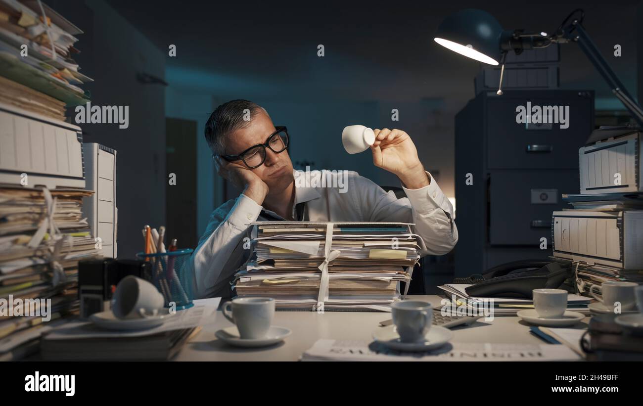 Exhausted sad employee overwhelmed workload hi-res stock photography ...