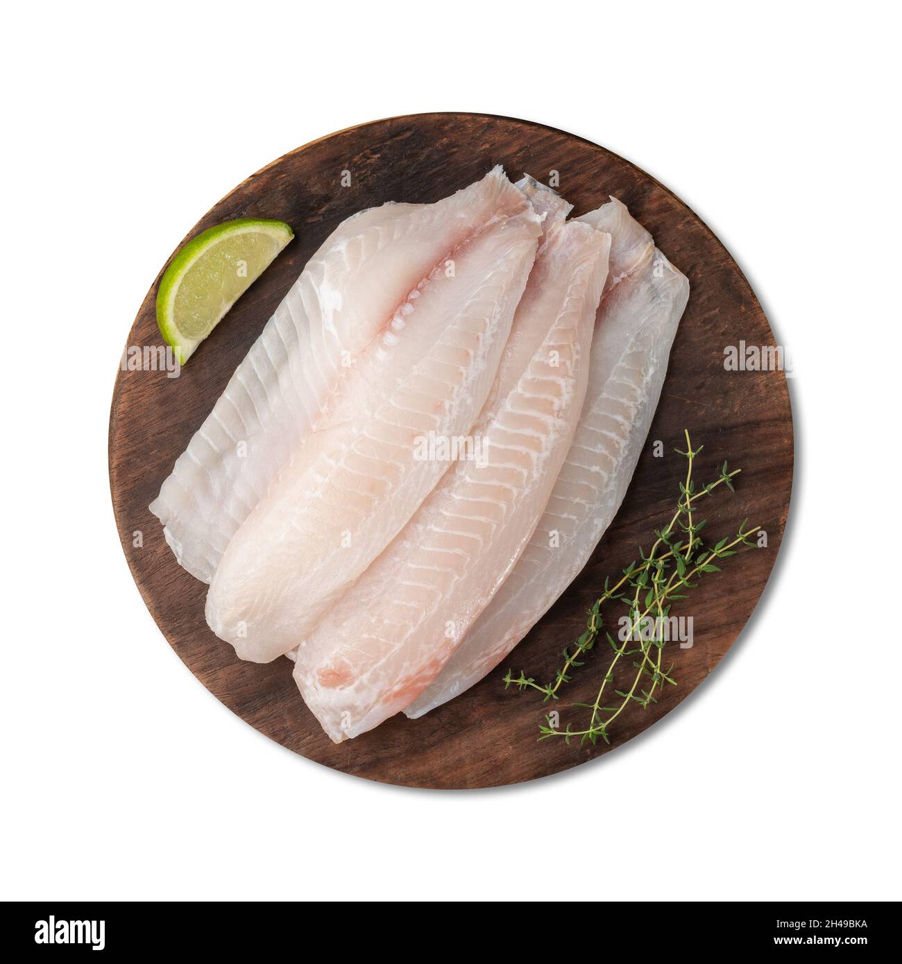 Raw tilapia fish fillet with seasonings isolated over white background ...