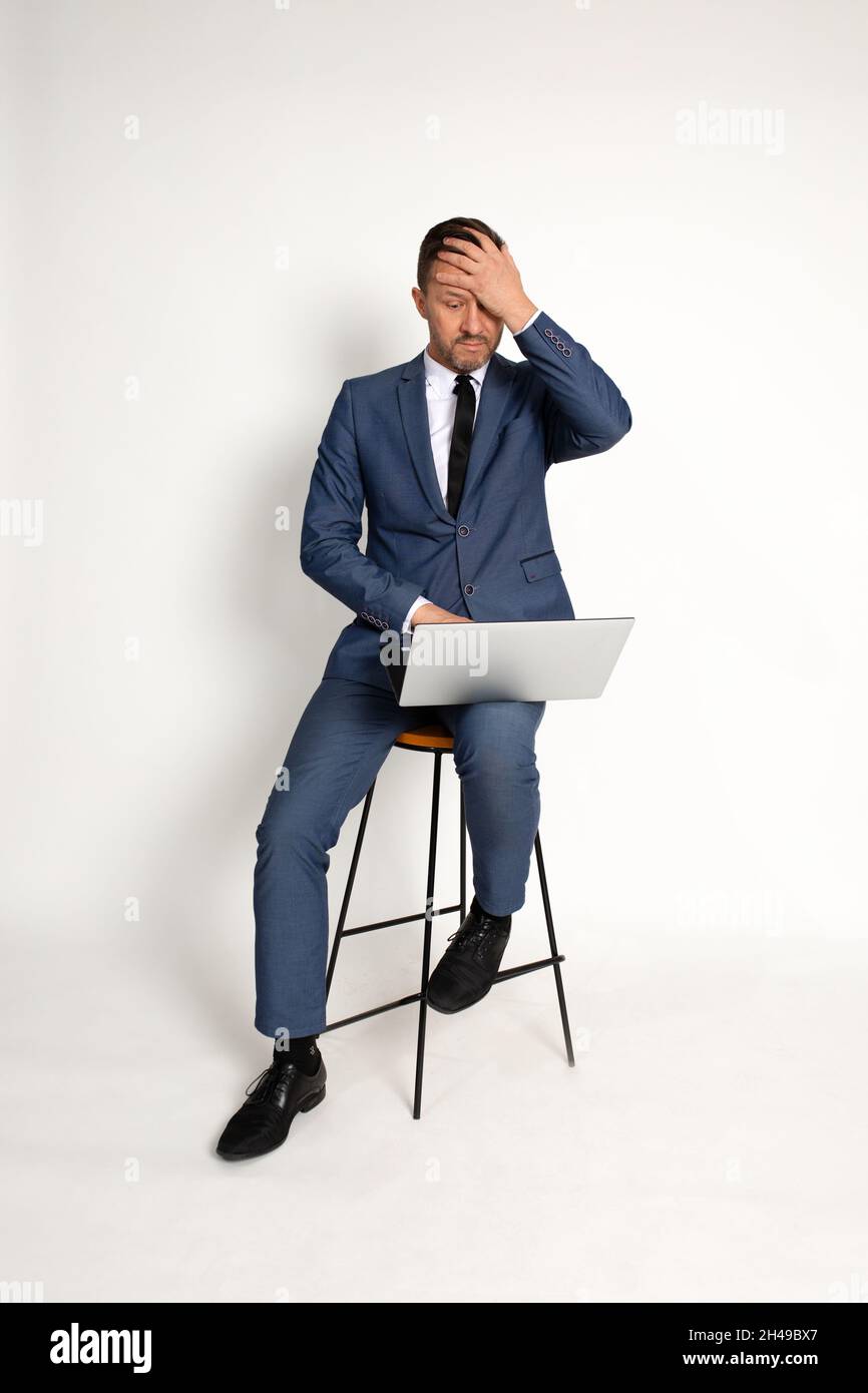 Contemplating businessman feeling sad, man working on laptop. Tired ...