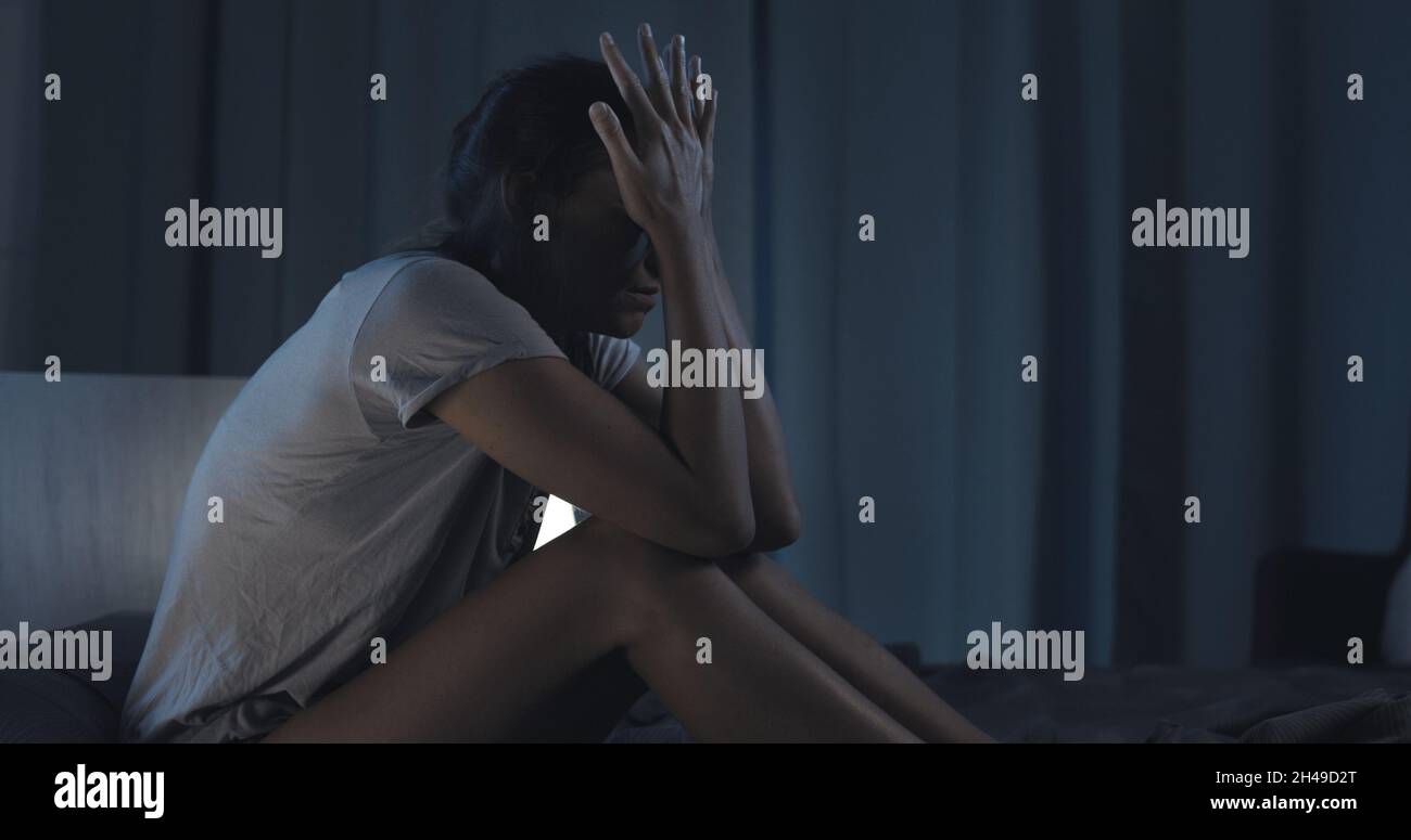 Sad woman awake late at night, she is suffering from insomnia Stock ...