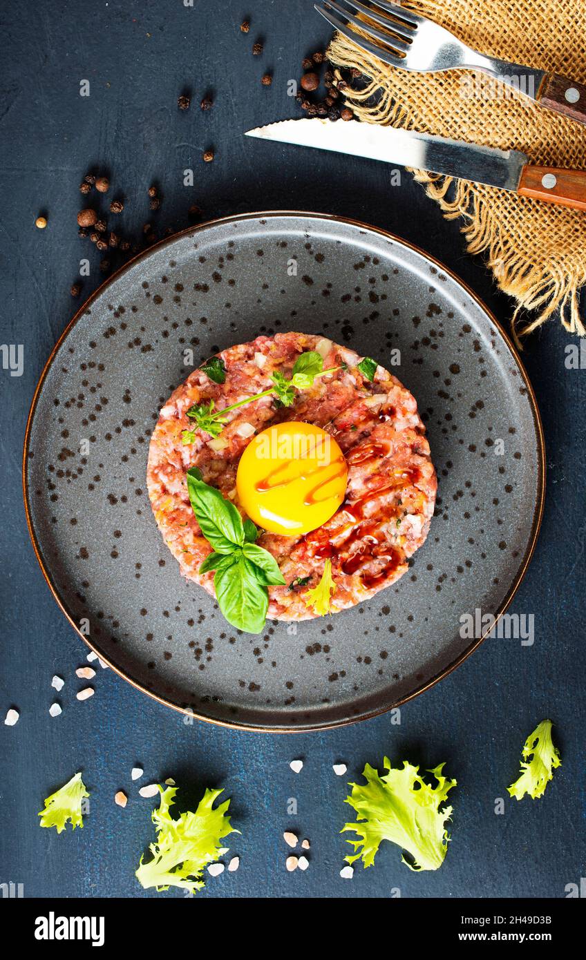 tar-tar from beef with raw yolk on plate Stock Photo - Alamy