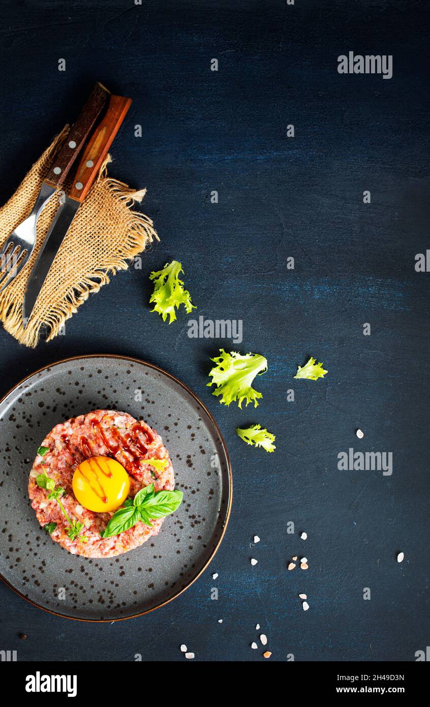 tar-tar from beef with raw yolk on plate Stock Photo - Alamy