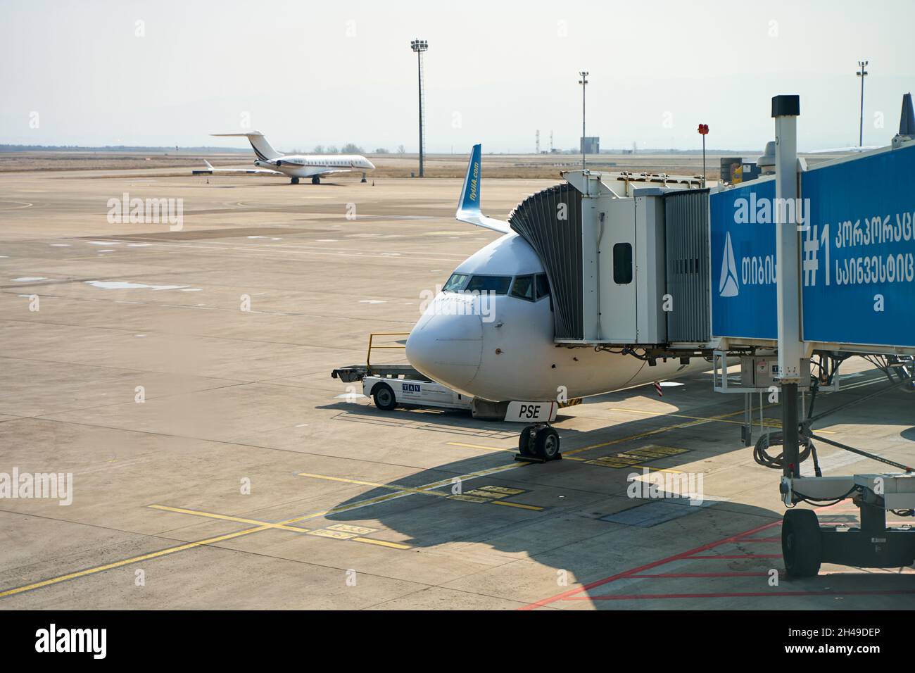 Airplane parking near the airport terminal. Tbilisi, Georgia - 03.16. ...