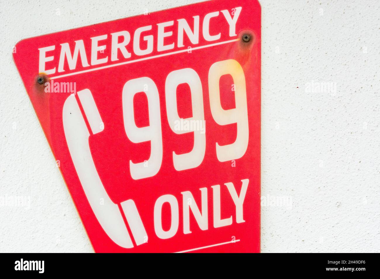 Emergency help phone sign on wall of a static lifeguard shelter on a ...