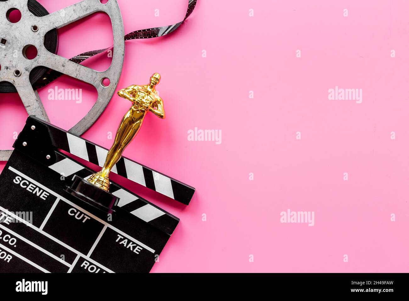 Golden movie award statue with film reel video tape and clapper board ...