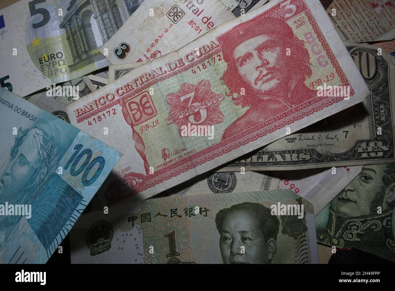 International banknotes over table with Cuban Che banknote on the top ...