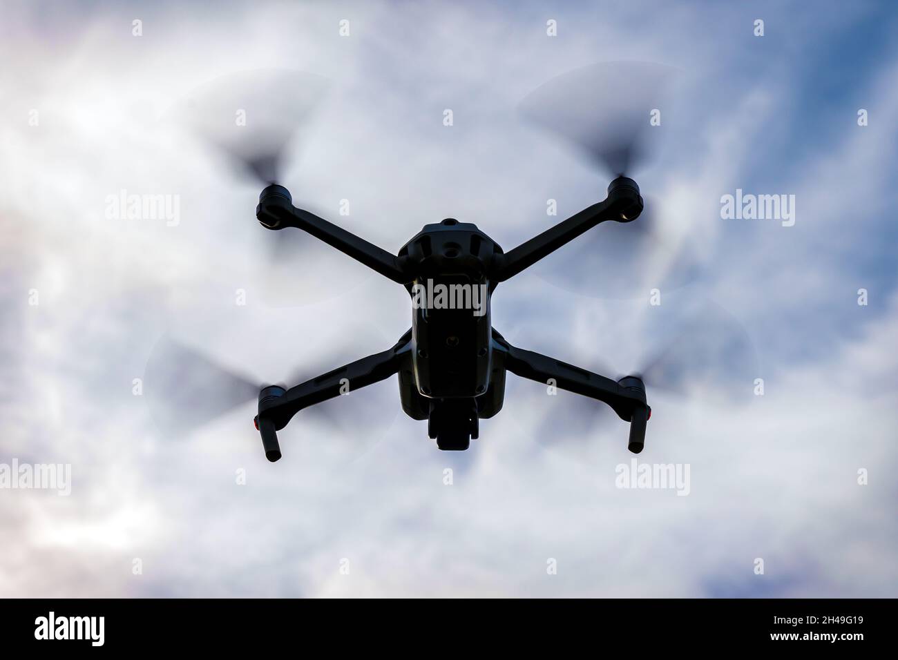 flying drone silhouette on dark cloudy sky background Stock Photo - Alamy
