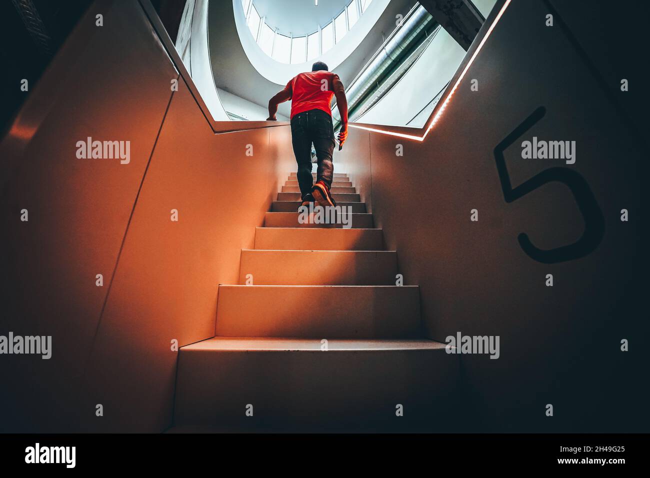 Man walking up the stairs Stock Photo - Alamy