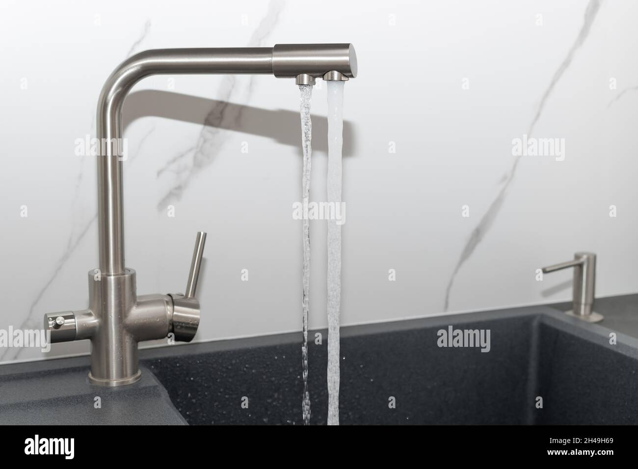 Purified and clean water pours from modern kitchen faucet Stock Photo ...