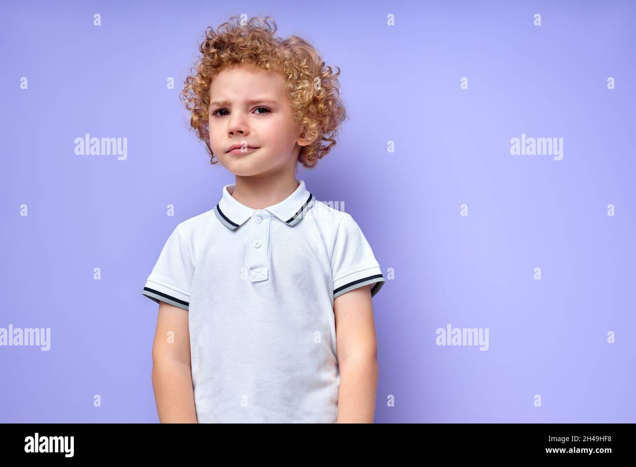 Portrait of unhappy dark skinned child with sullen look, curves lips ...