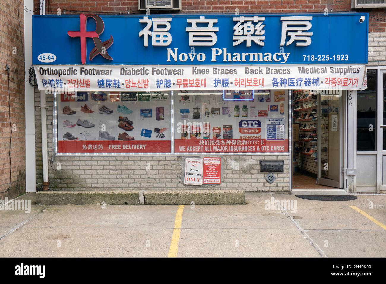 The exterior of the Novo Pharmacy with signs in Korean & English. On ...