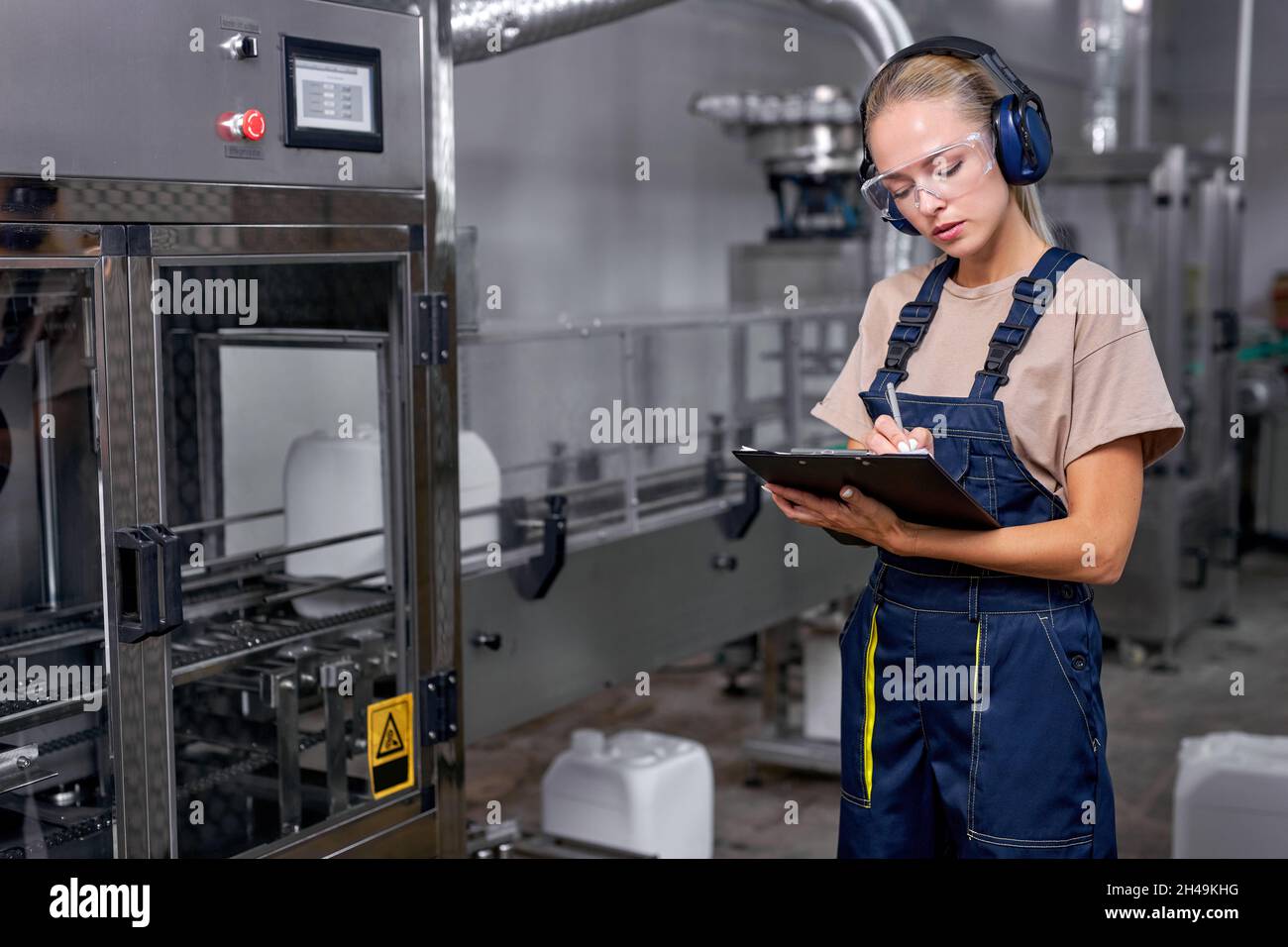 Female engineer worker hold inspection control, in protective workwear ...