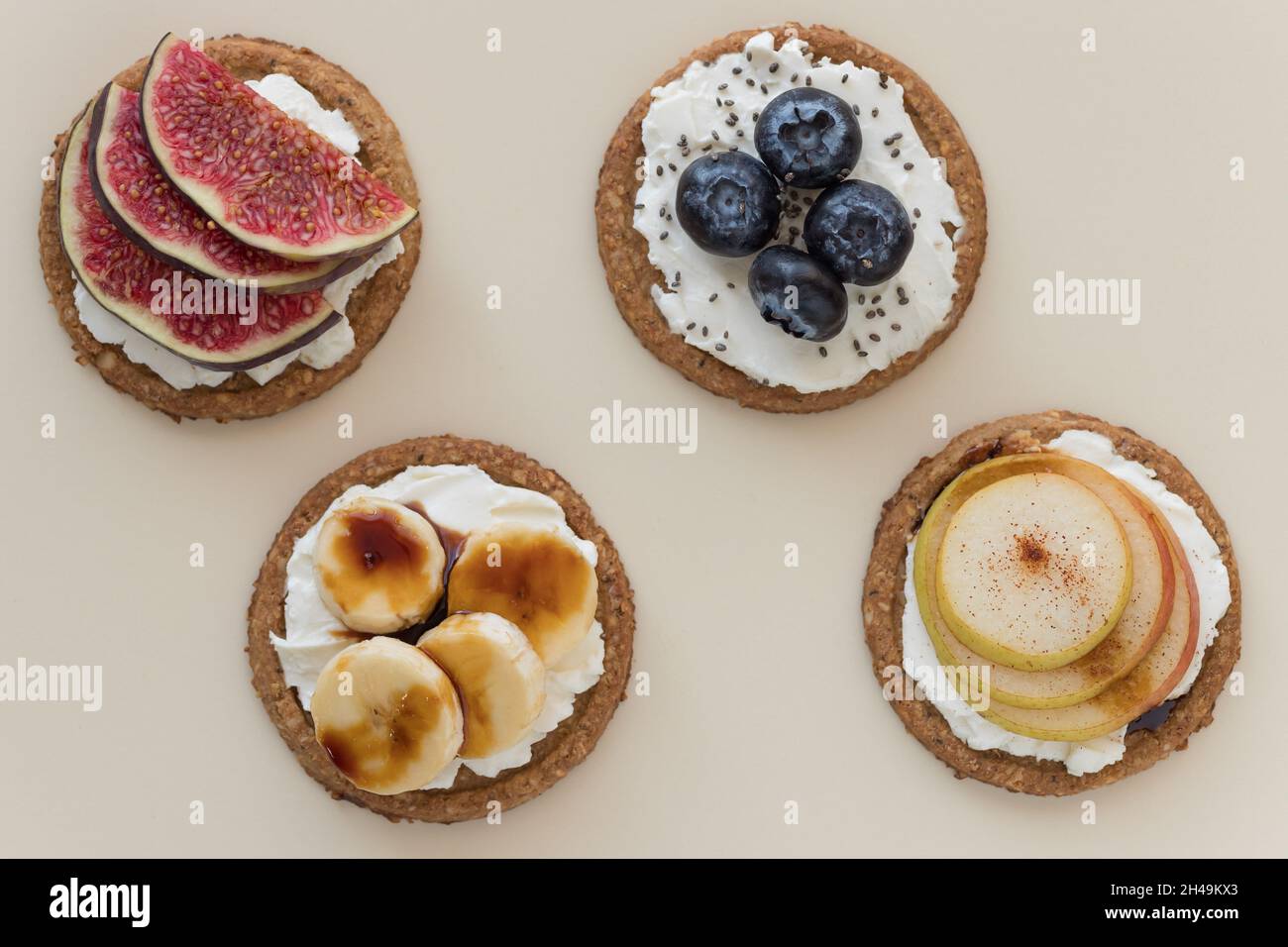 Oat cakes with different toppings on beige background Stock Photo - Alamy