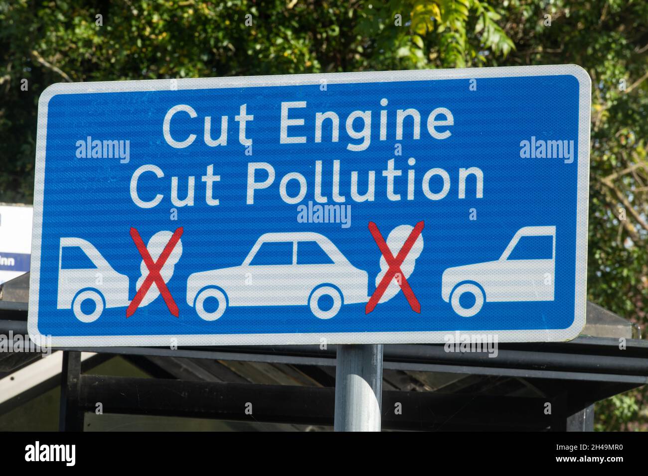 Cut Engine Cut Pollution road sign next to a level crossing on the ...