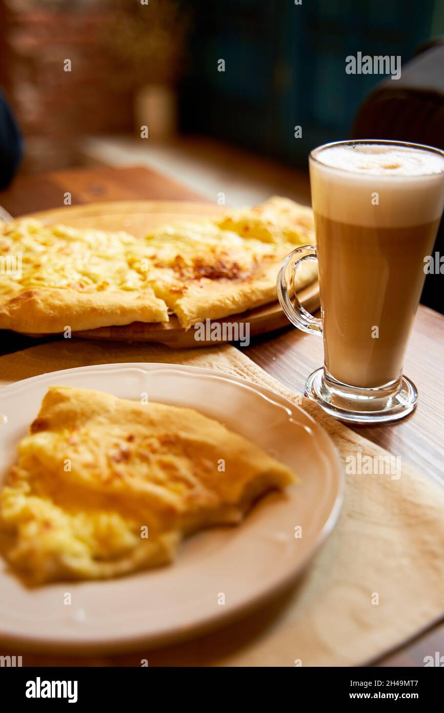 Lunch at a cafe. Khachapuri and latte Stock Photo - Alamy