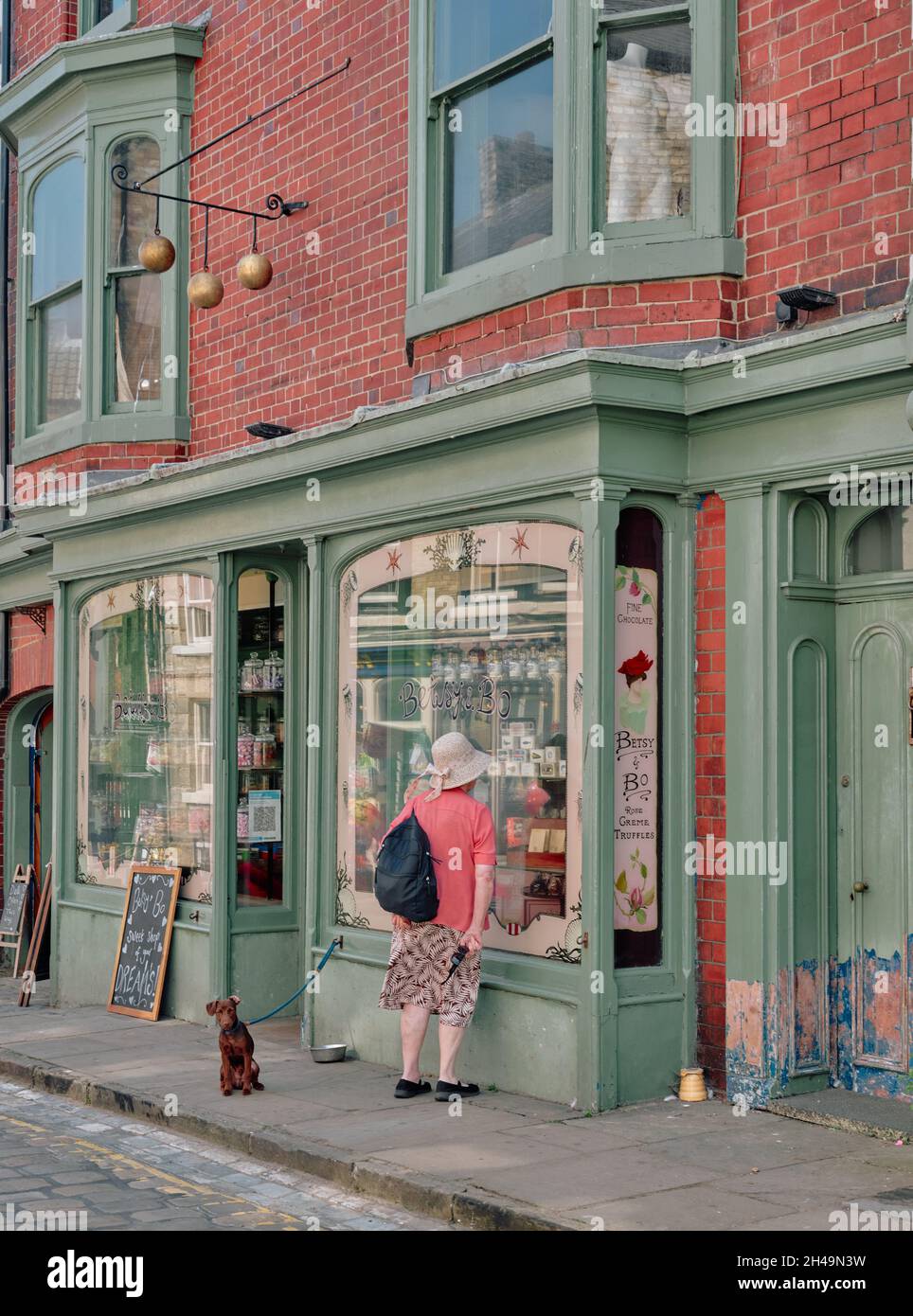 A tourist window shopping in Staithes seaside village in the borough of ...