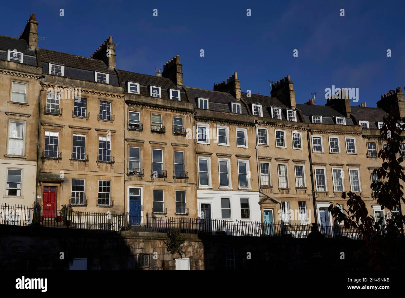 Sunlit terrace of Georgian buildings in Walcot Parade in the historic ...