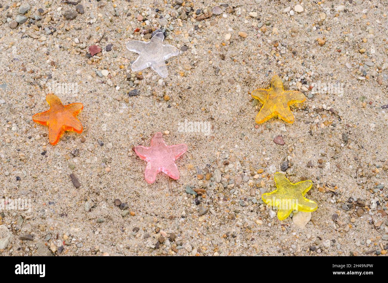 Five decorative stars on the background of beach sand, the concept of a ...