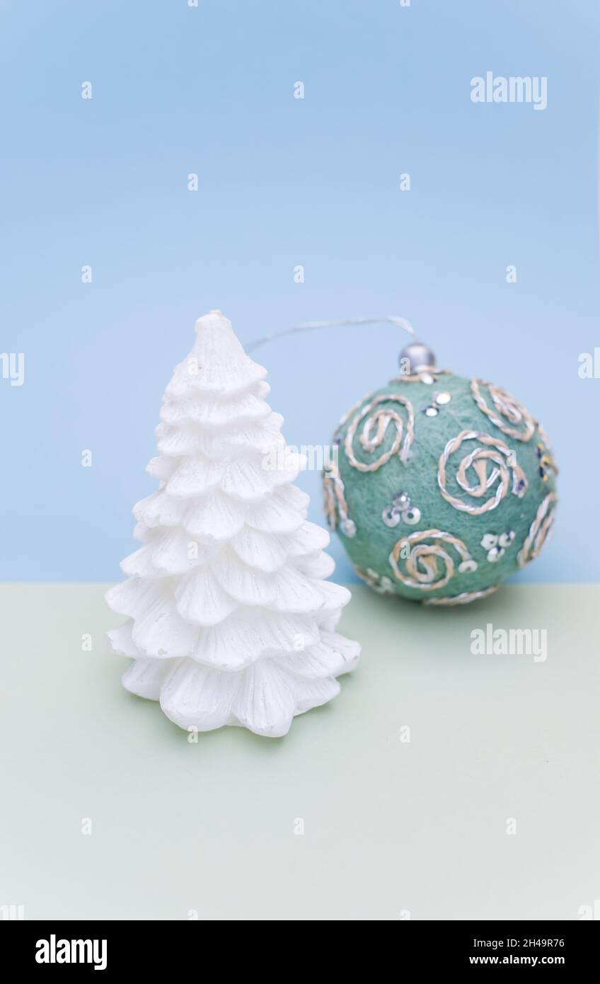 white decorative wax fir trees on a green blue background with text ...