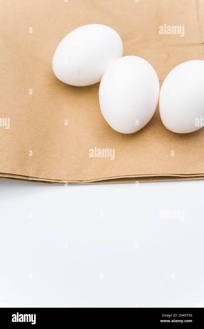 isolated white eggs on a white and brown paper background Stock Photo ...