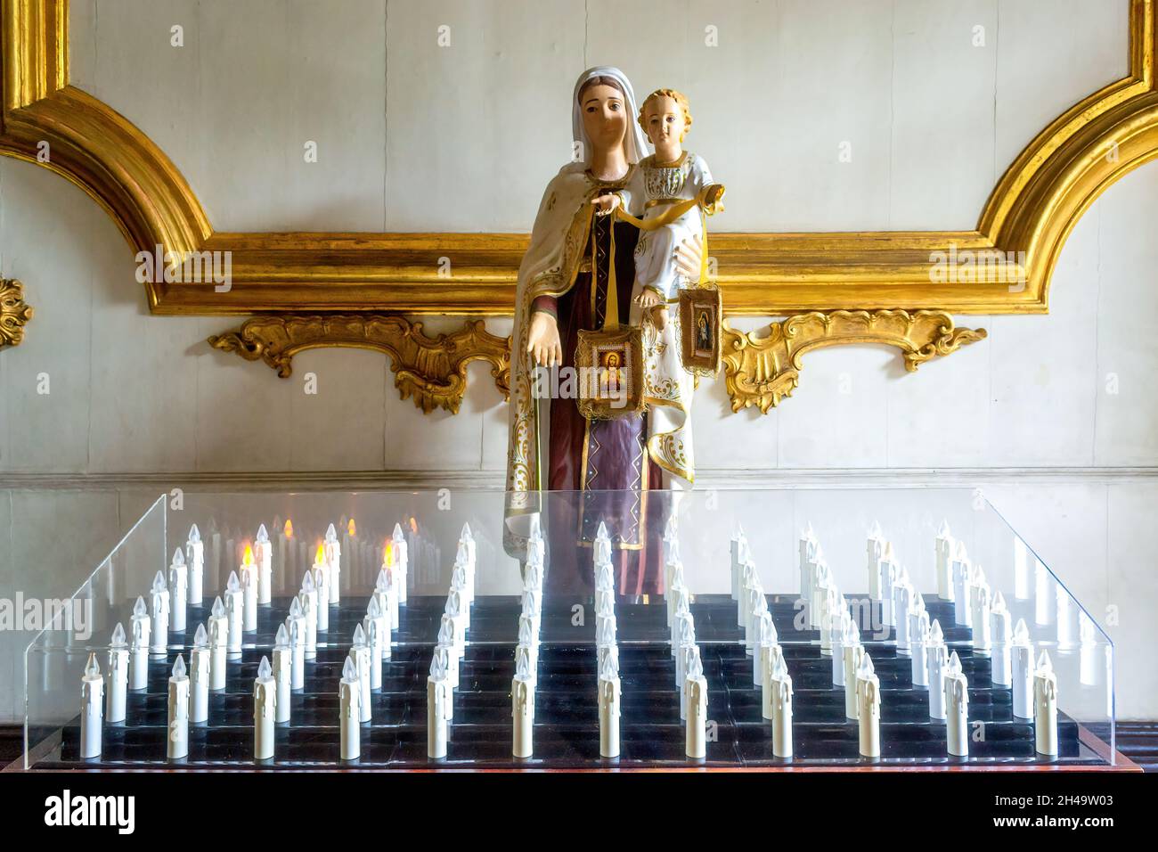 Religious virgin statue with candles part of the interior architecture ...