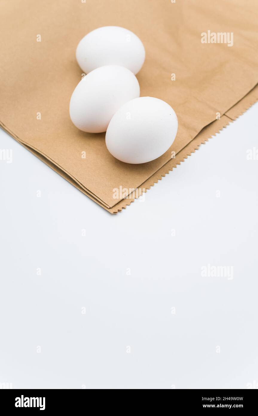 isolated white eggs on a white and brown paper background Stock Photo ...
