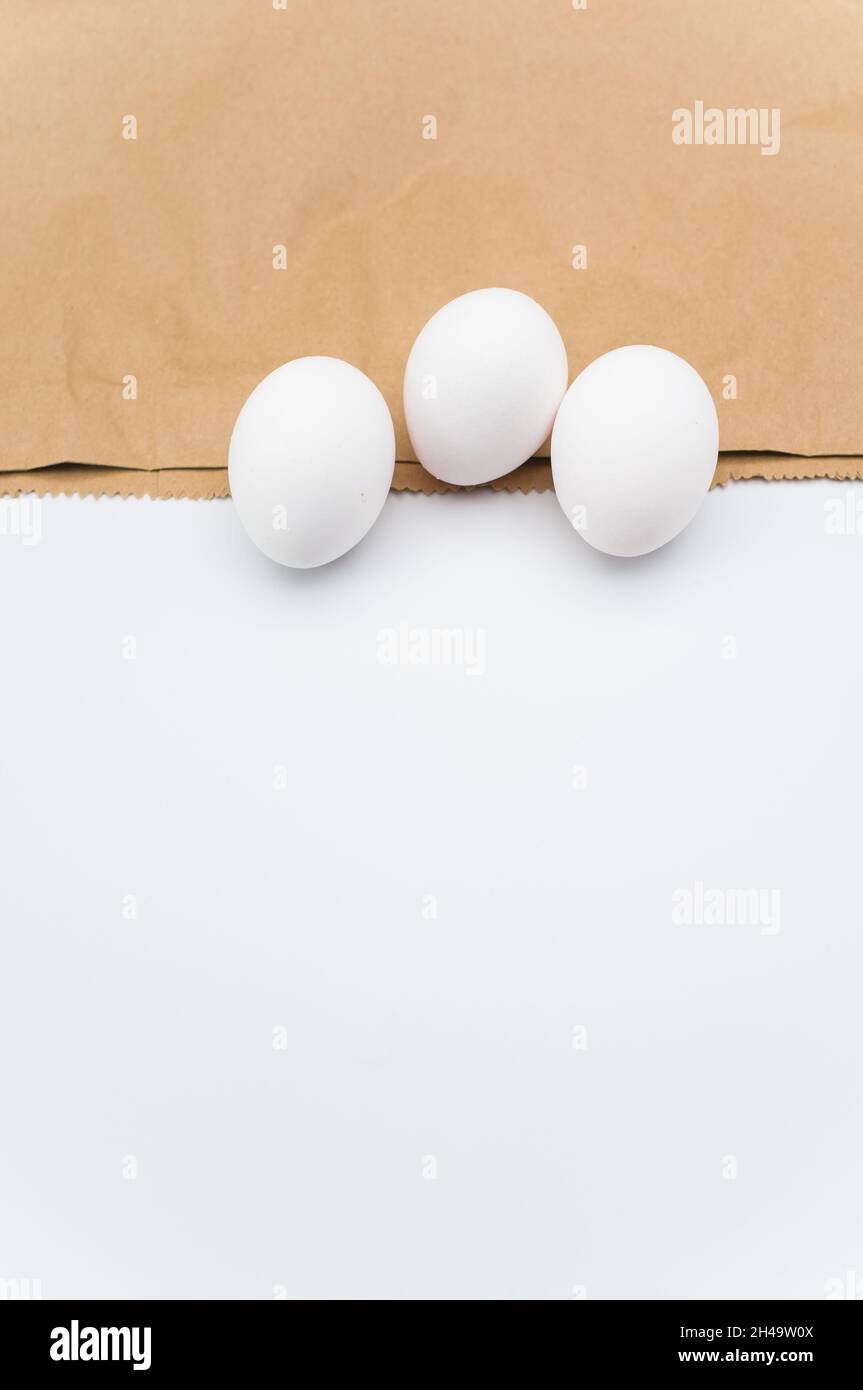 isolated white eggs on a white and brown paper background Stock Photo ...