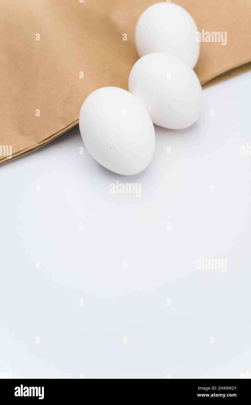 isolated white eggs on a white and brown paper background Stock Photo ...