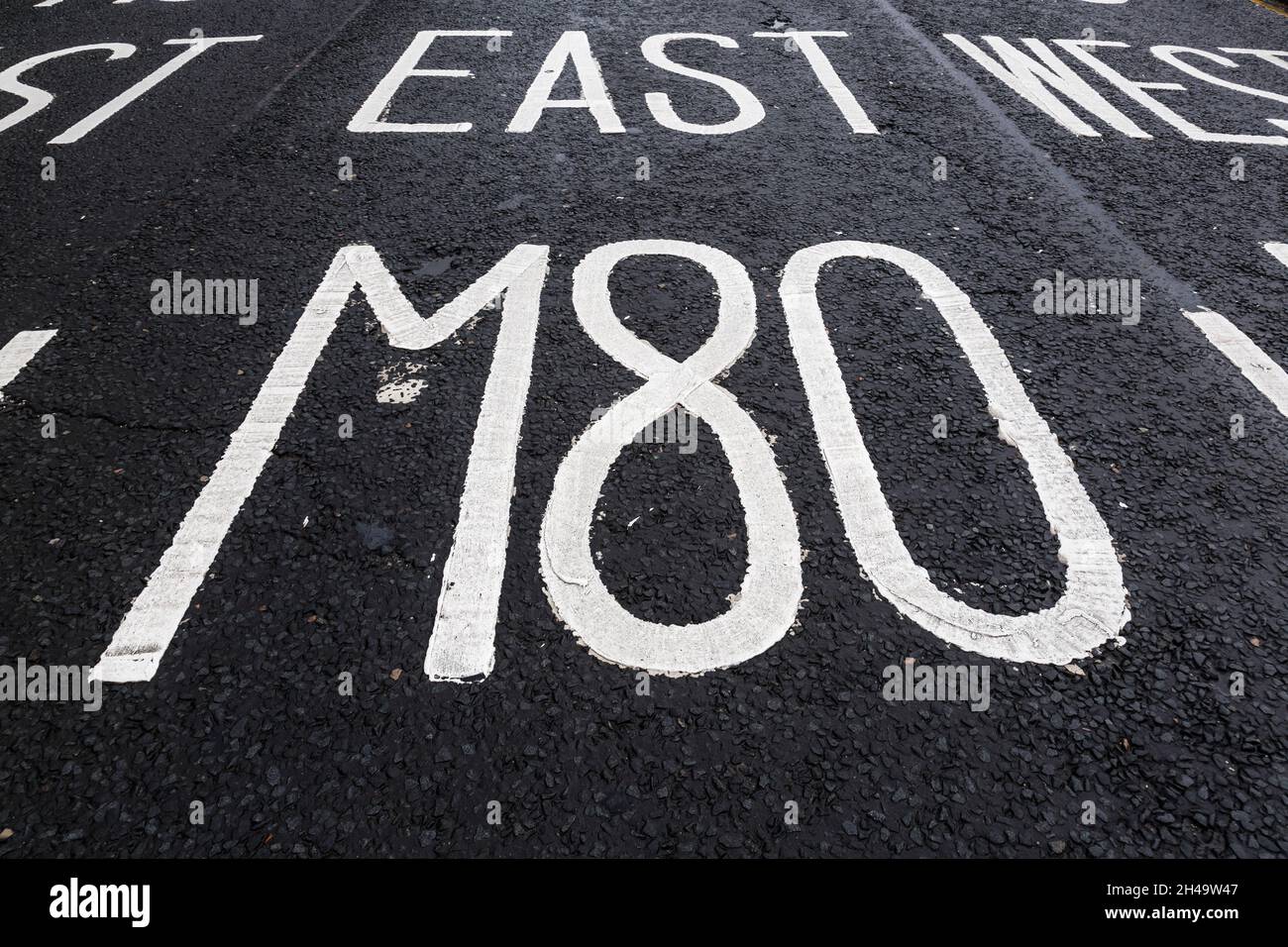 M80 Motorway direction sign painted on a road, Glasgow, Scotland, UK ...