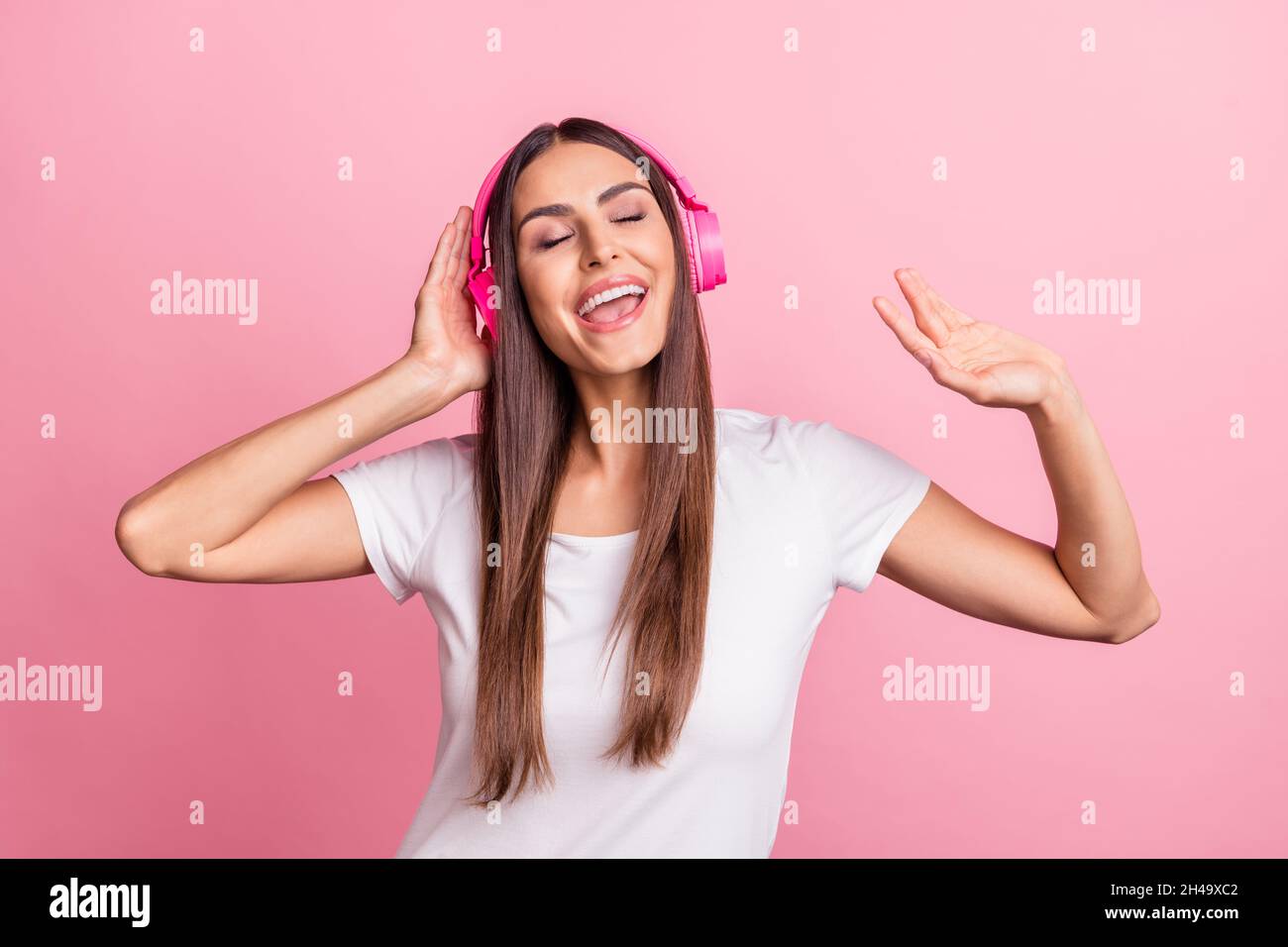 Portrait of attractive dreamy cheerful girl listening single dancing ...