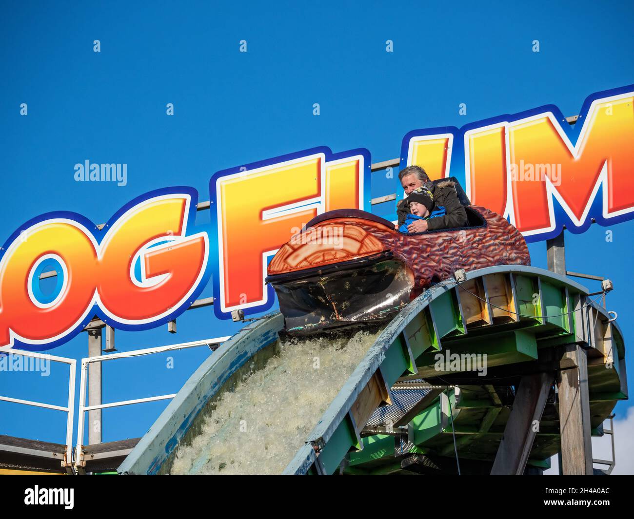 Log flume water theme park ride about to go over drop two people in ...