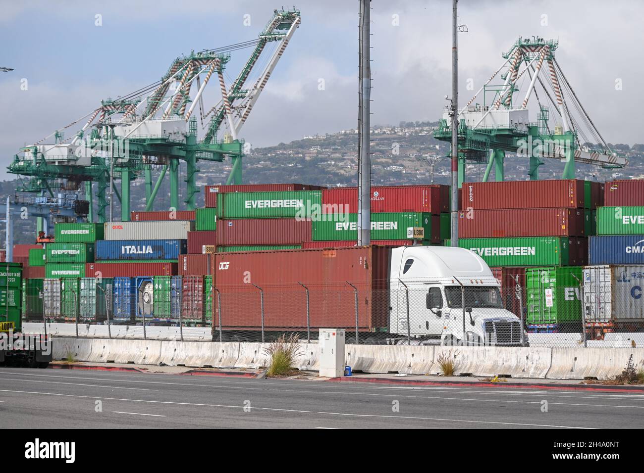 Trucks haul shipping containers at the Port of Los Angeles on October ...