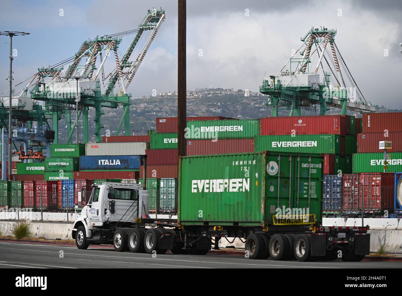 Trucks haul shipping containers at the Port of Los Angeles on October ...