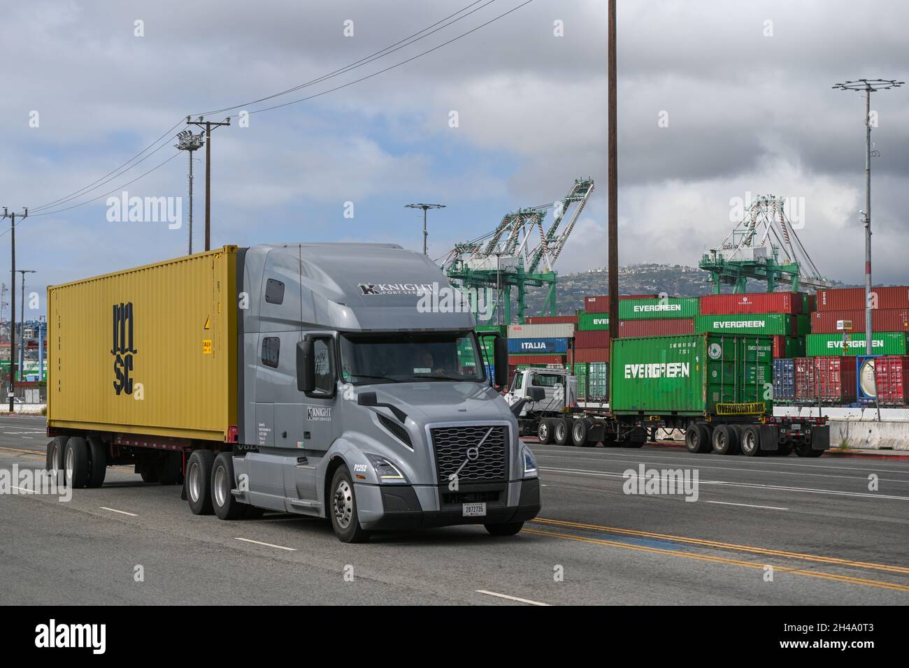 Trucks haul shipping containers at the Port of Los Angeles on October ...