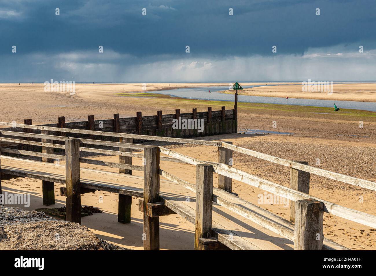 A rain storm over the sea on the beach at Wells next the Sea, Norfolk ...