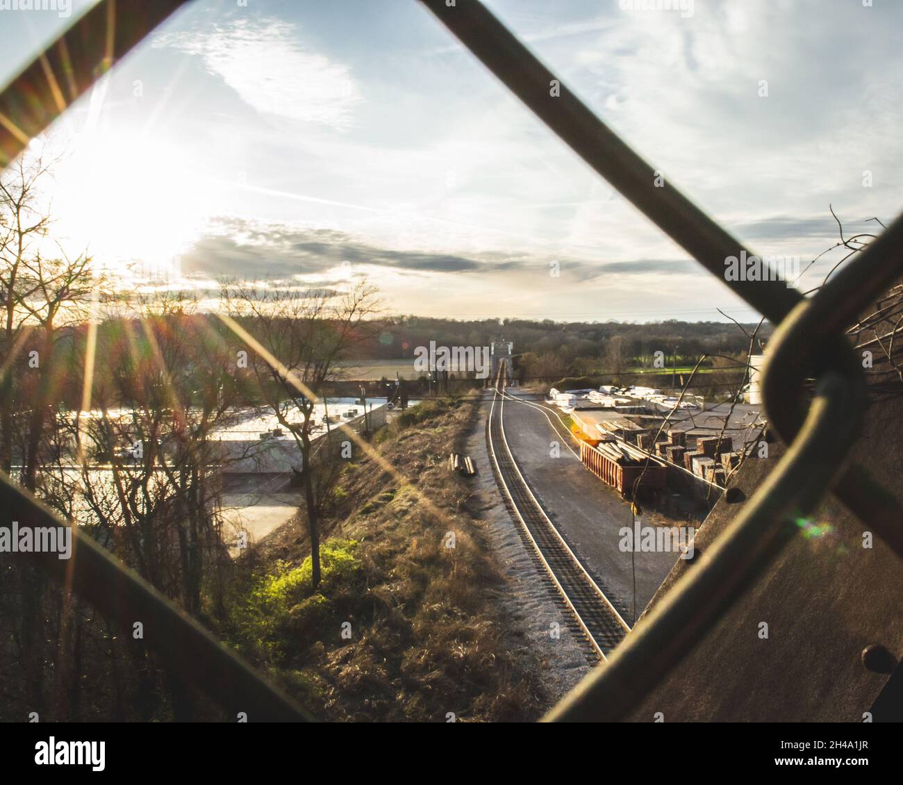 View of a railway on a sunny day visible through a metal net Stock ...