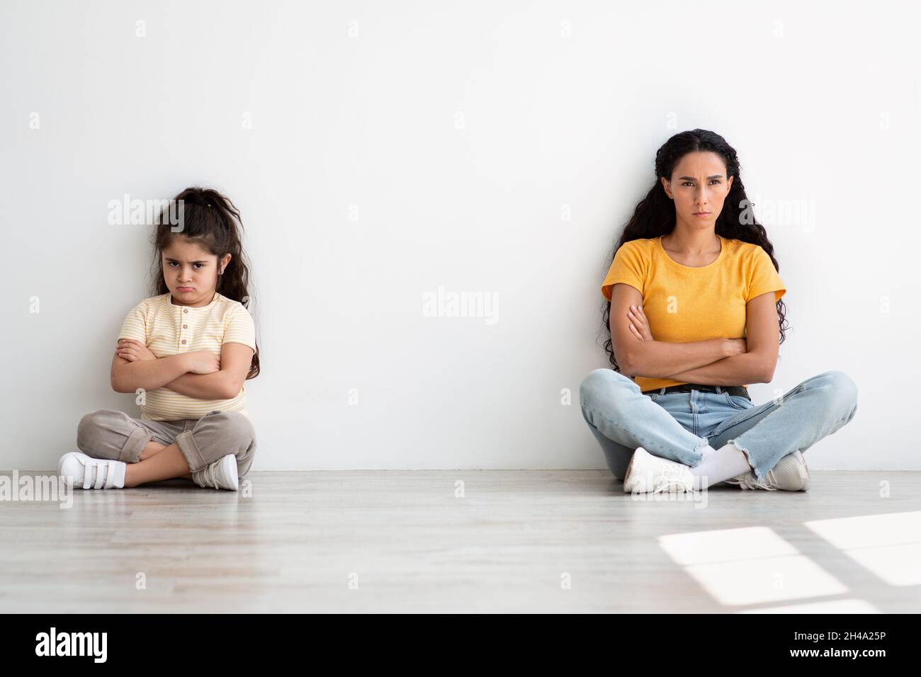 Portrait Of Grumpy Young Mother And Her Little Preschooler Daughter ...