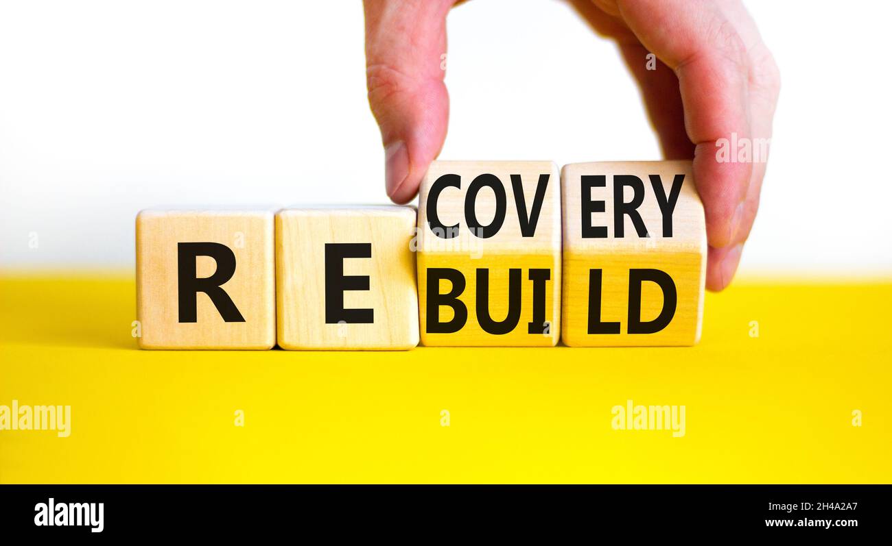 Recovery and rebuild symbol. Businessman turns cubes and changes the ...
