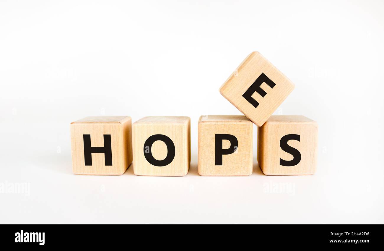 Hopes symbol. The concept word 'hopes' on wooden cubes. Beautiful white ...