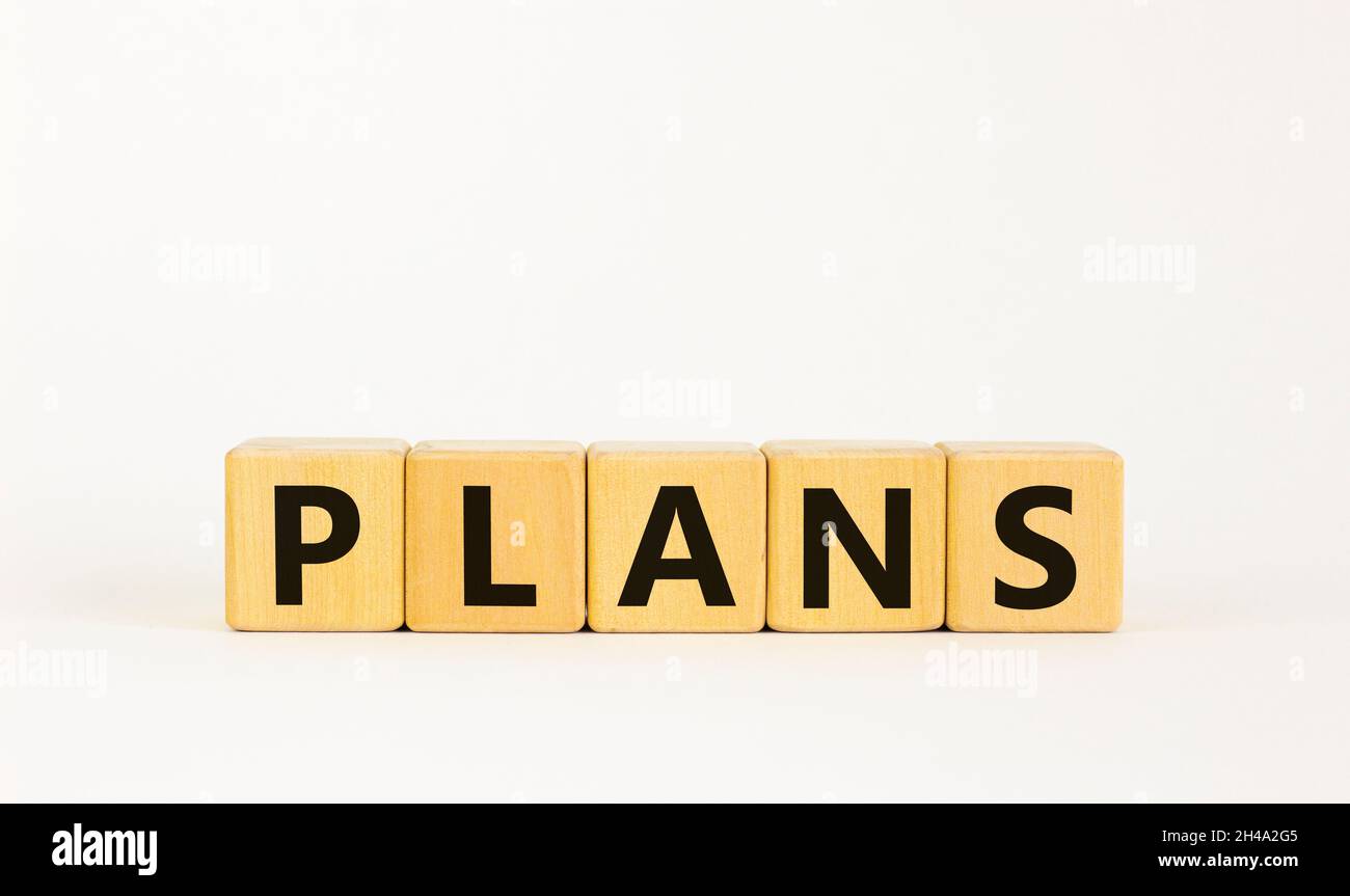 Plans symbol. The concept word 'plans' on wooden cubes on a beautiful ...
