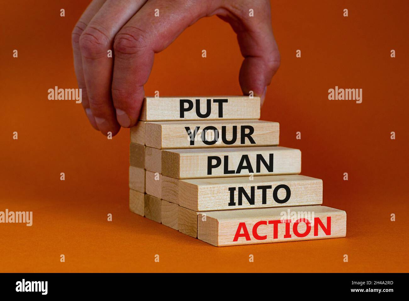 Put your plan into action symbol. Wooden blocks with words Put your ...