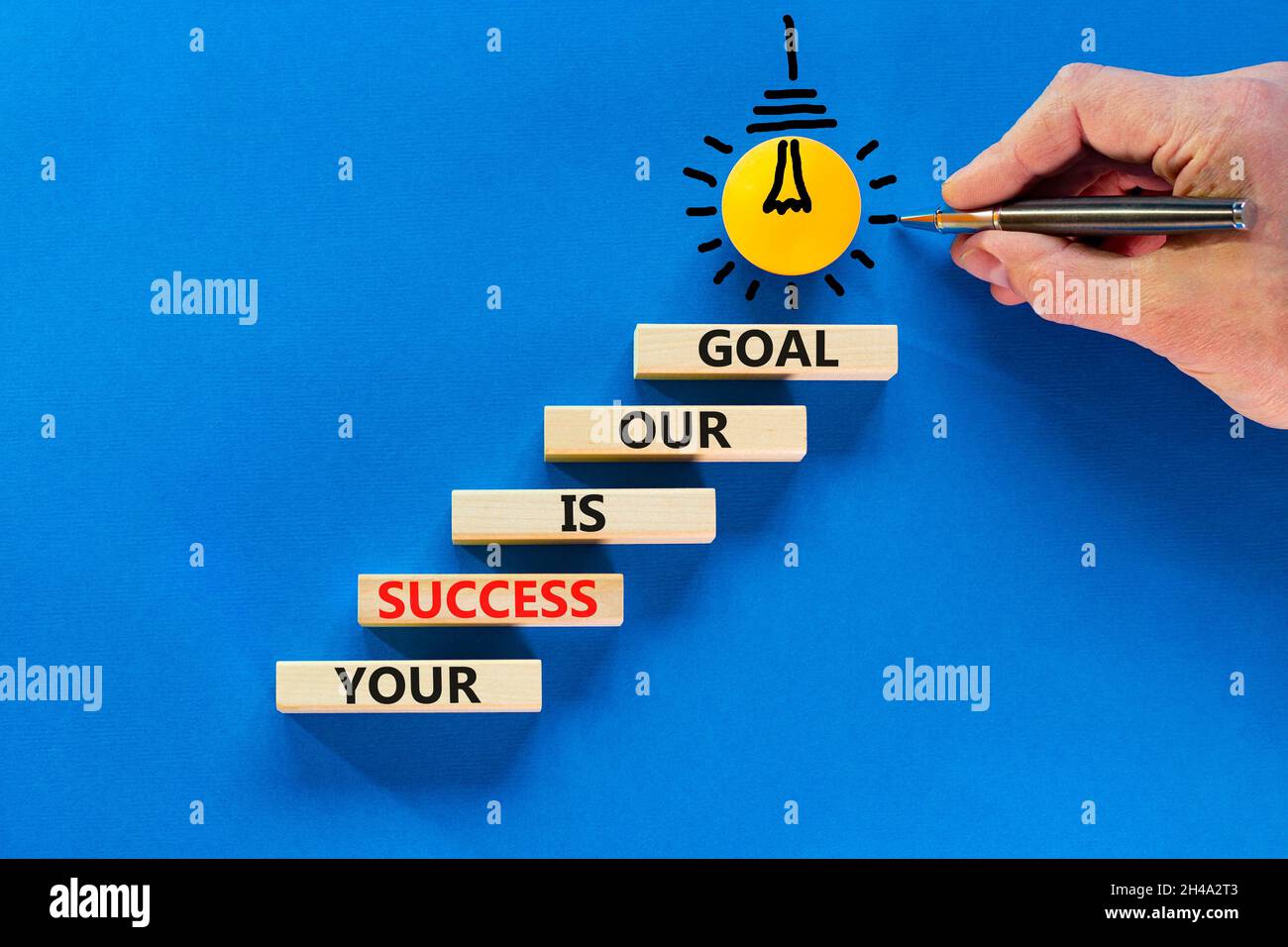 Your success is our goal symbol. Wooden blocks with words Your success ...