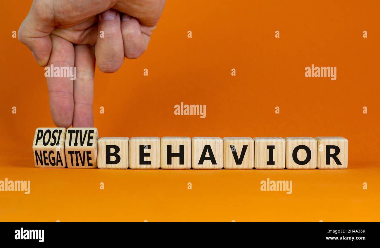 Positive or negative behavior symbol. Businessman turns cubes, changes ...