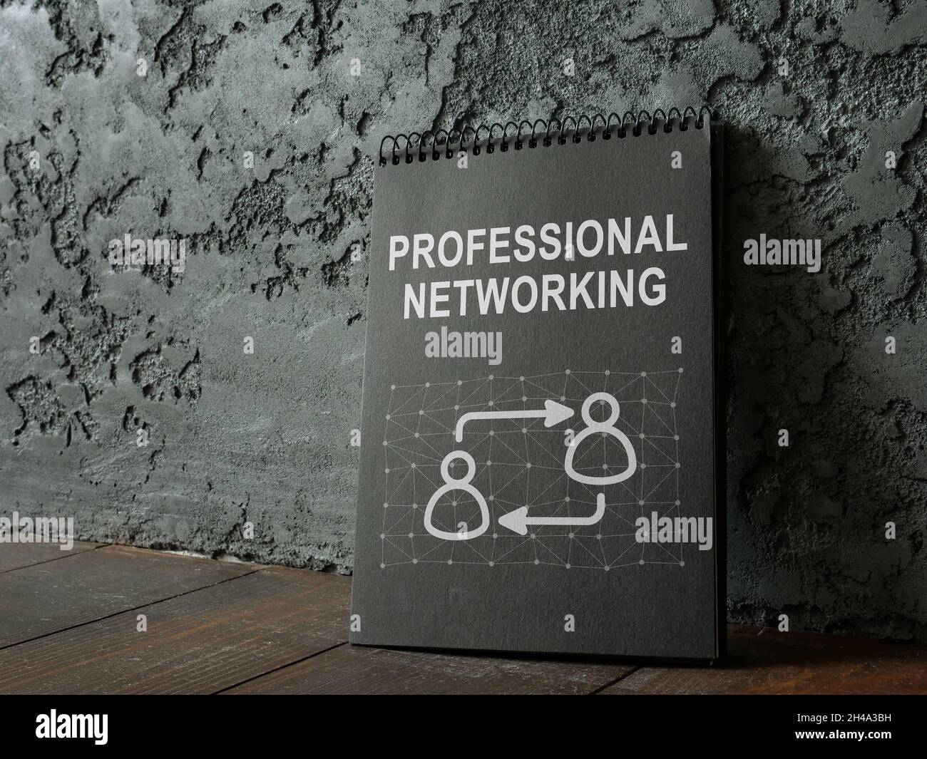 Notebook near wall with professional networking sign Stock Photo - Alamy
