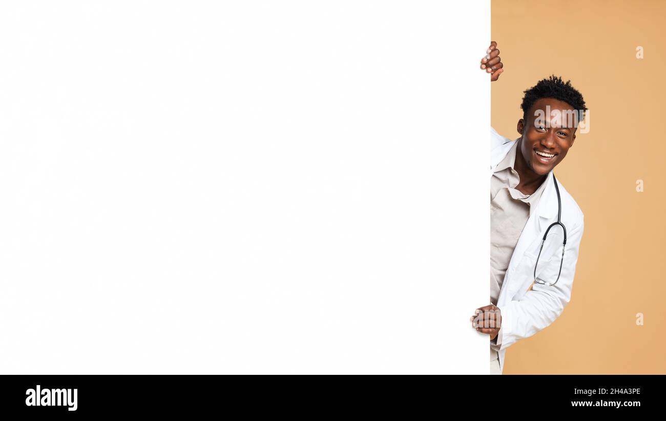 Medical Ad. Positive Black Male Doctor Peeking Out Of Big Blank ...
