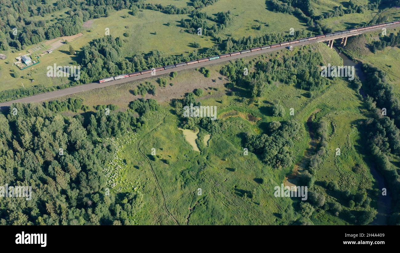 Train on high railway line with railway bridge. Aerial drone view of ...