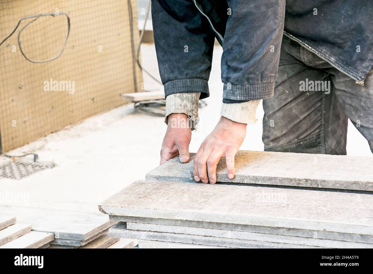 A man polishes a granite slab with a grinder. Work on stone with an ...