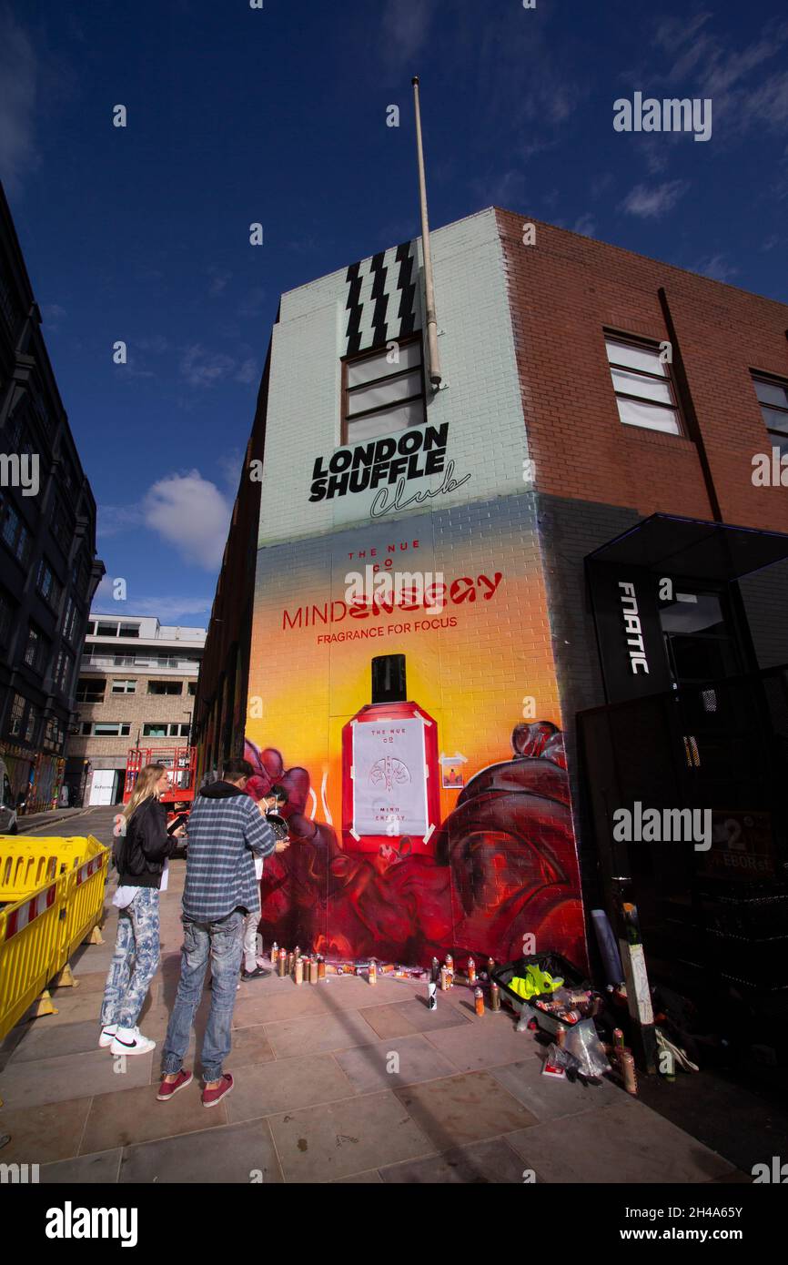 Graffiti artists decorating the wall of the London Shuffle Club ...