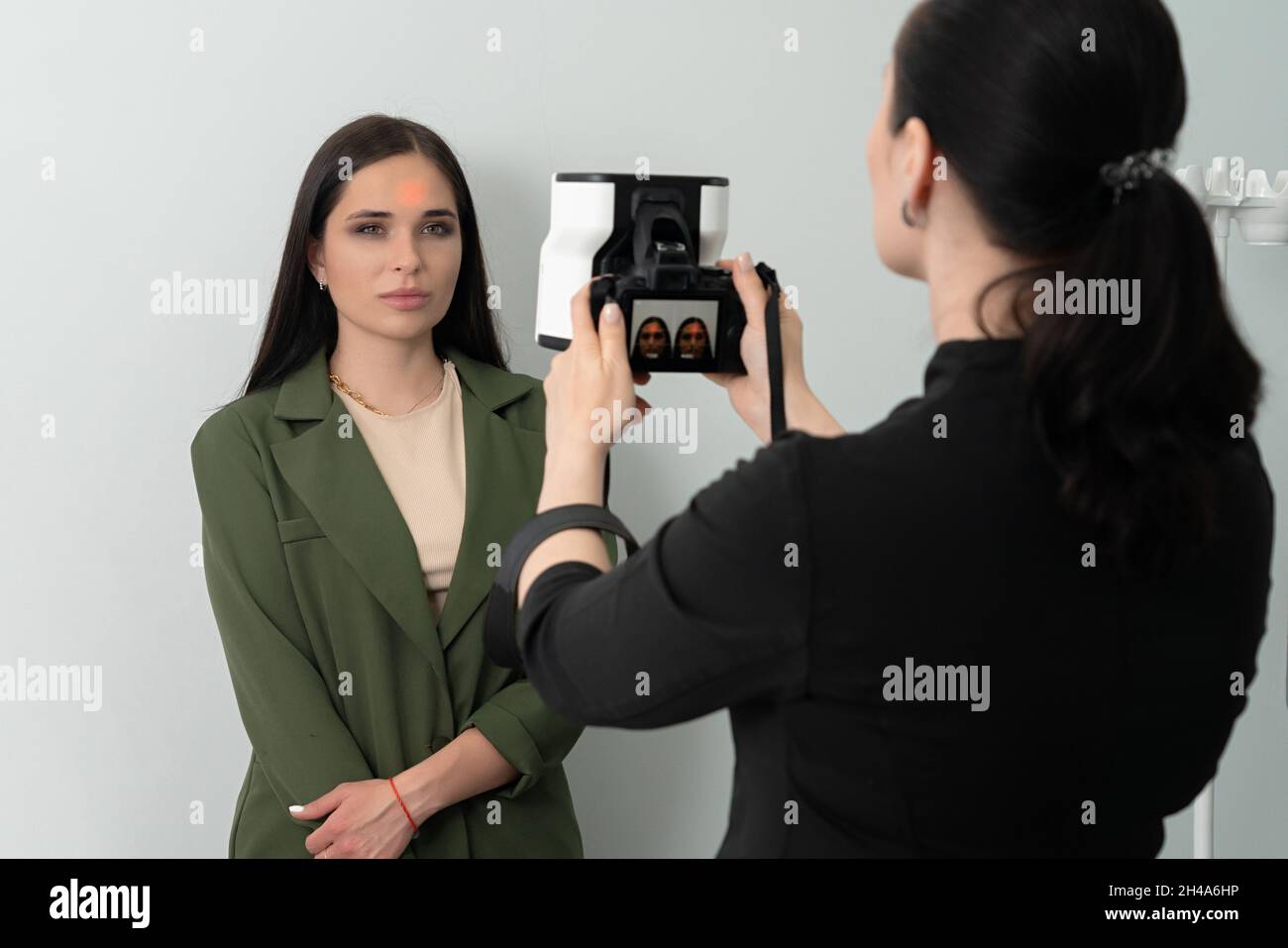 Doctor taking picture of female patient before aesthetic treatment on ...
